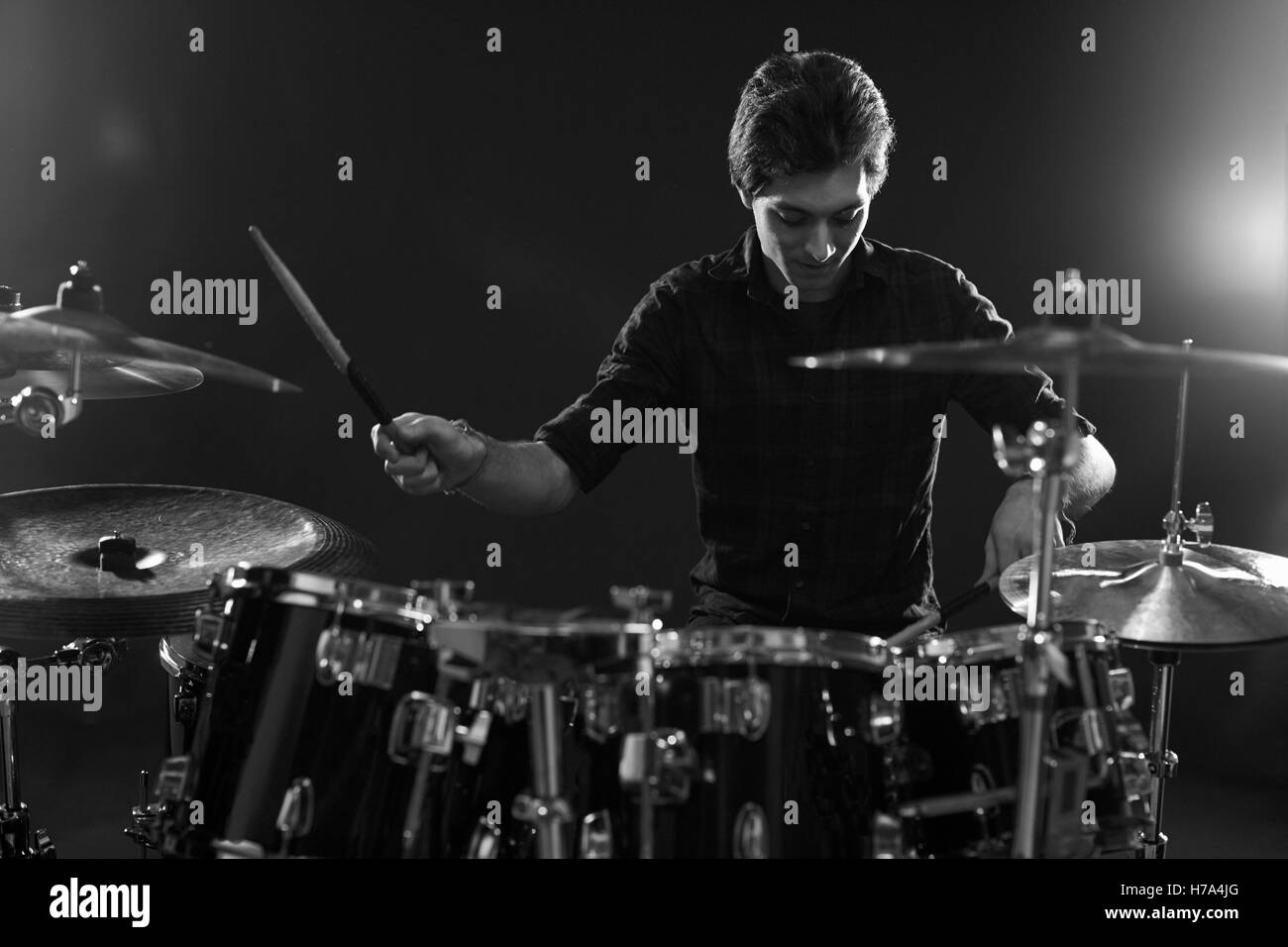 Tourné en noir et blanc du kit de batterie batteur jouant en Studio ...