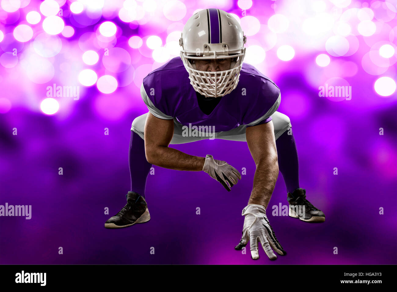 Joueur de football avec un uniforme violet sur la ligne de scrimmage ...