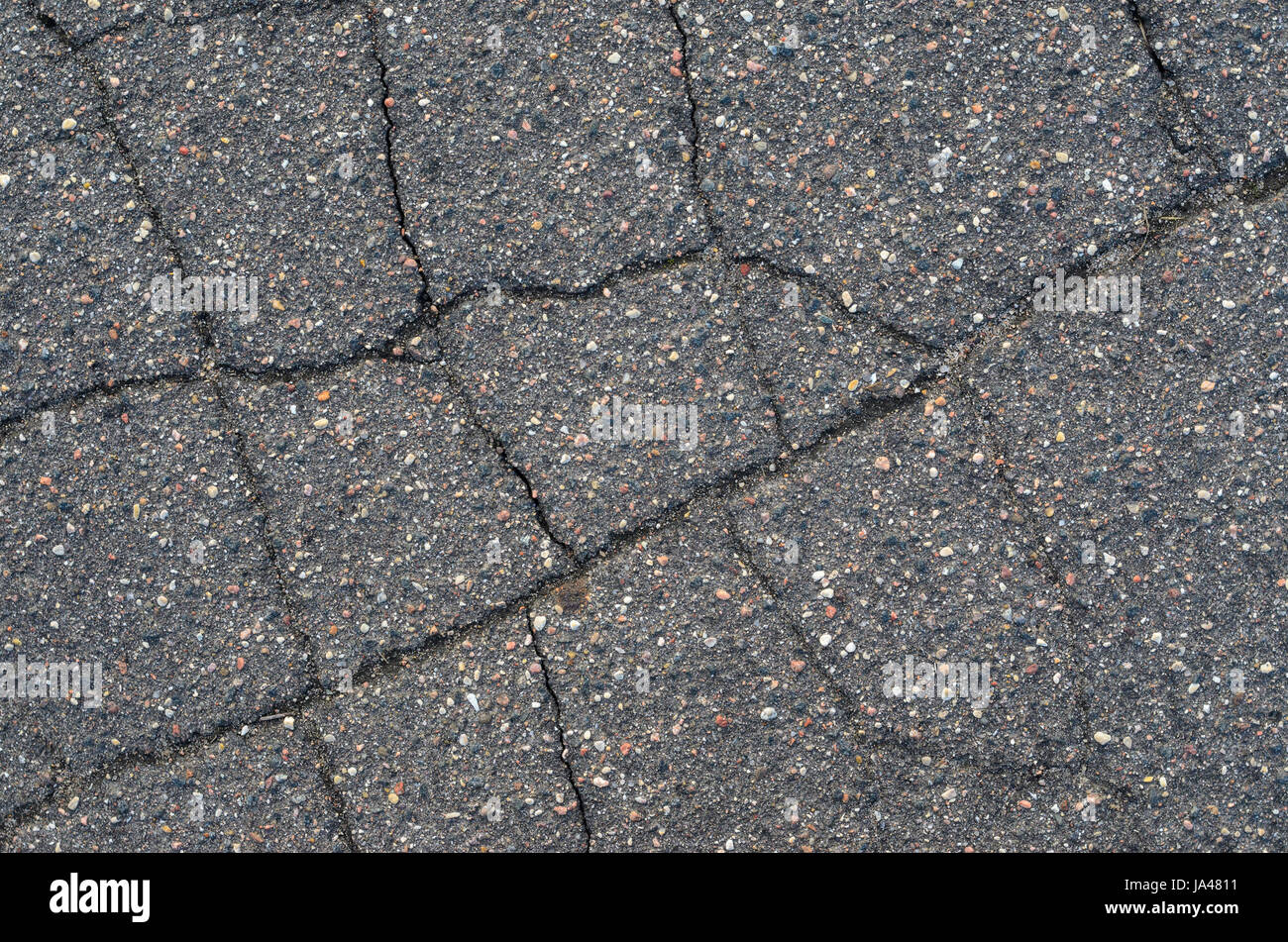 La texture d'asphalte avec des fissures. La texture de l'asphalte ...