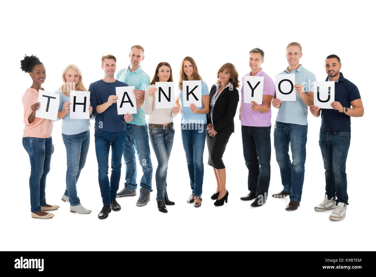 Portrait de creative business people holding merci sign against white ...
