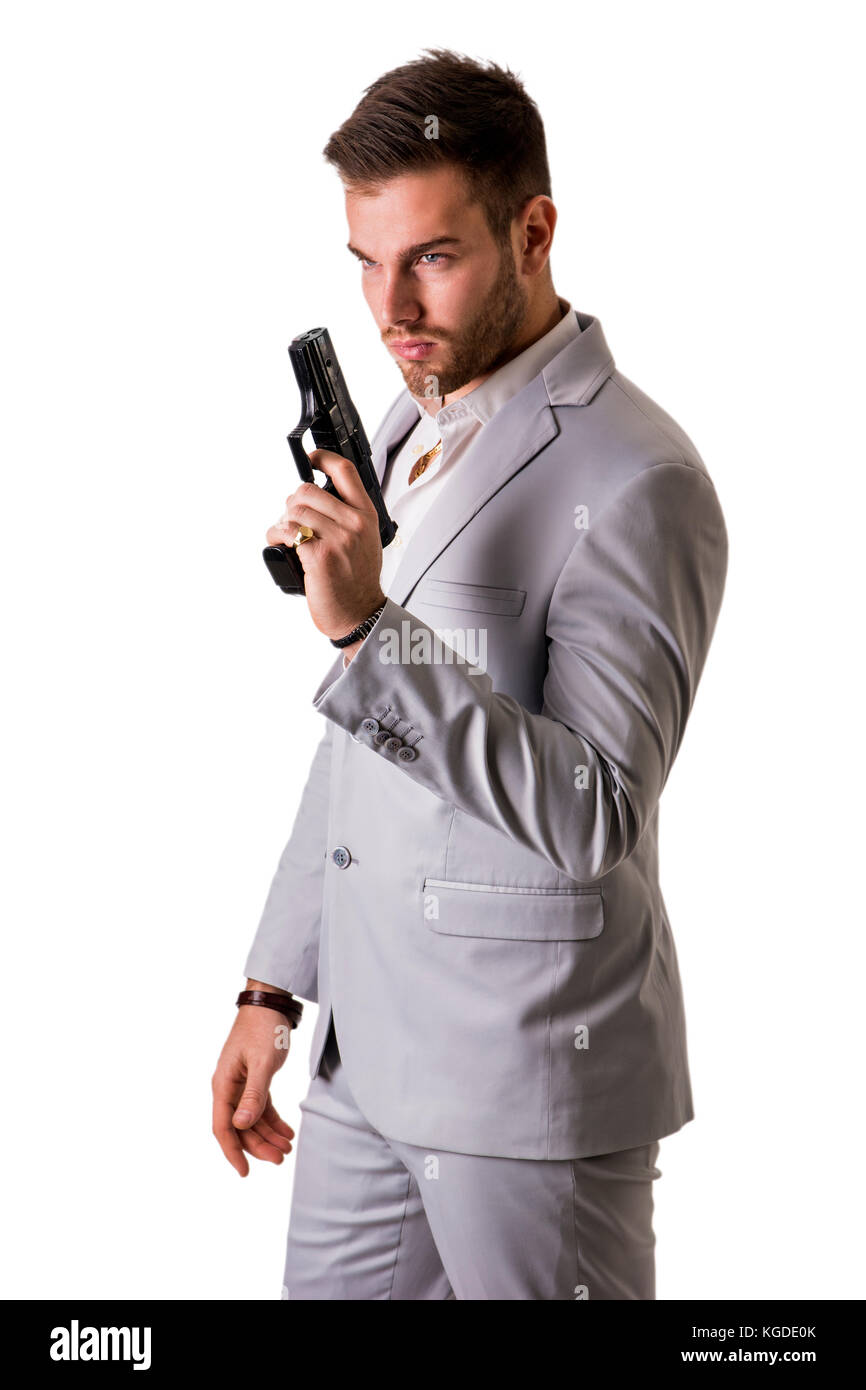 Homme élégant avec arme à feu, habillé comme un espion ou agent secret ...