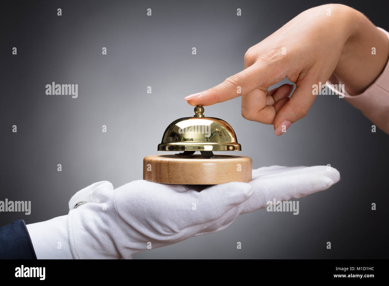 Customer Ringing Service Bell tenue par le client en face de l arriere plan gris Photo Stock Alamy
