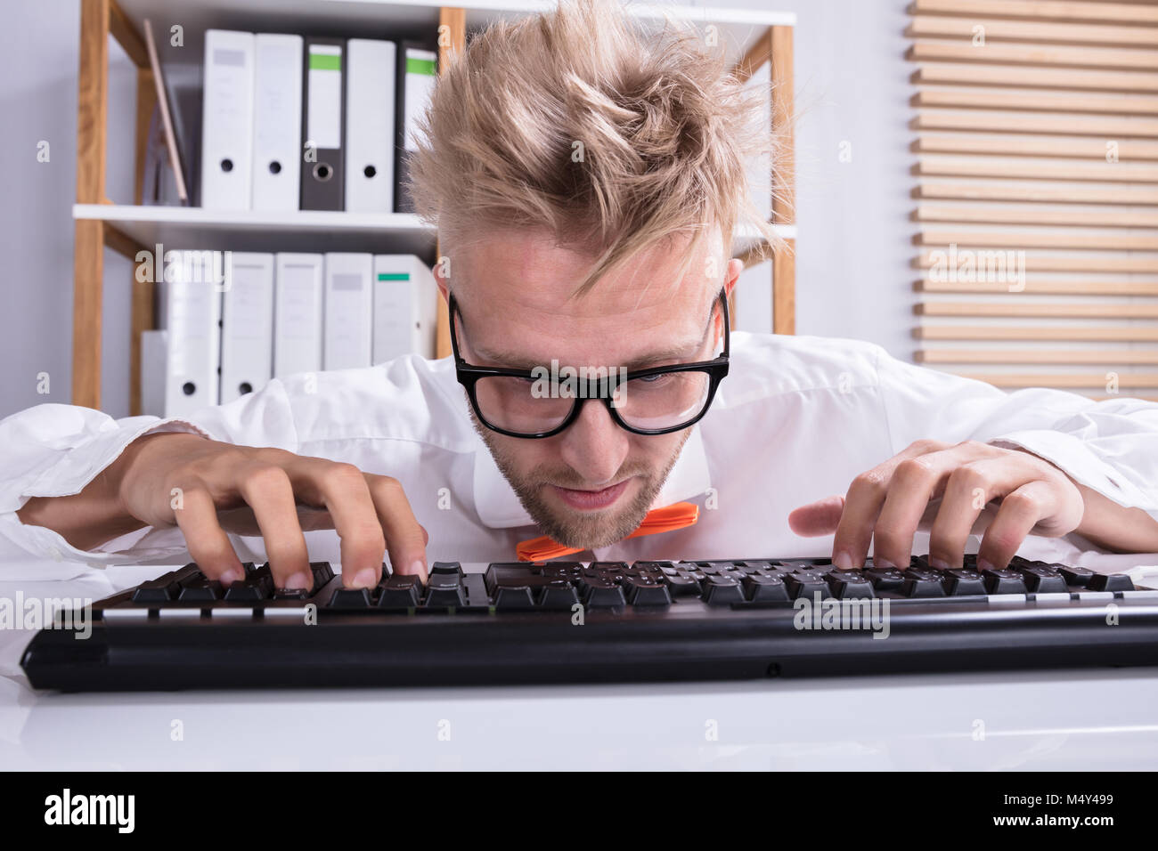 Nerd typing on keyboard Banque de photographies et d’images à haute ...