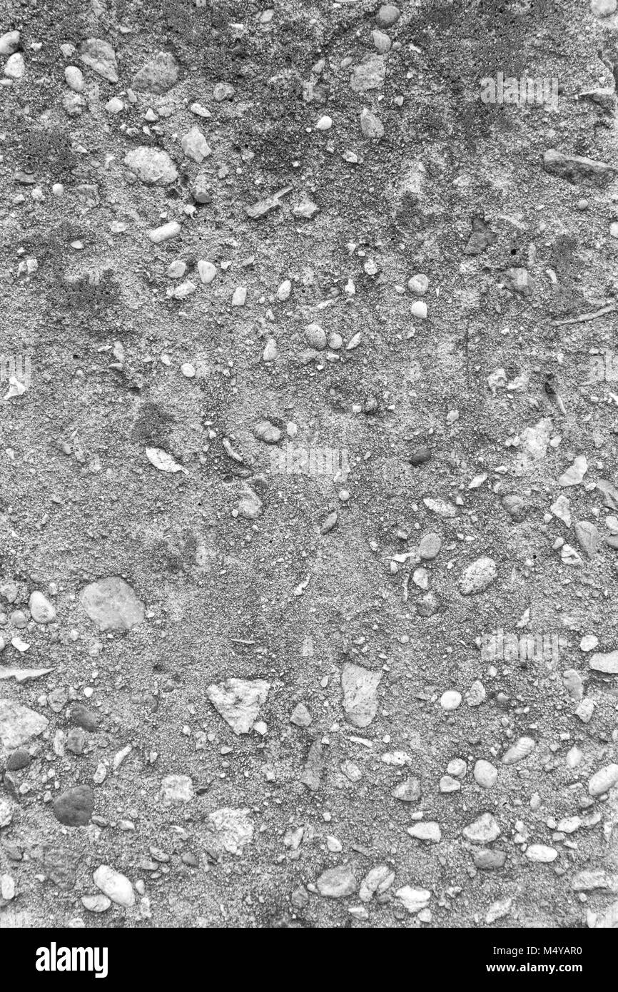 Close-up d'un mur en béton avec des petits cailloux embarqués texture ...