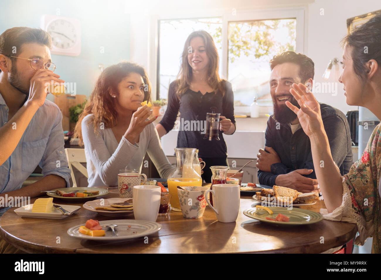 Un groupe multi ethnique de personnes autour d'une table Banque de ...
