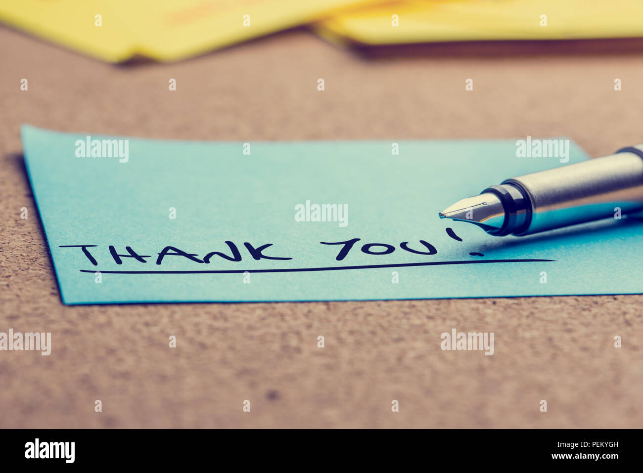 Note de remerciement manuscrite écrit sur un post-it bleu allongé sur ...