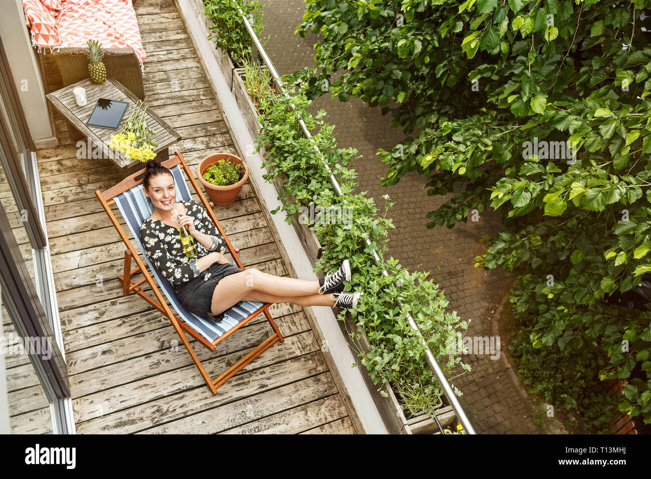 Jeune femme assise dans une chaise longue Banque de photographies et d’images à haute résolution ...