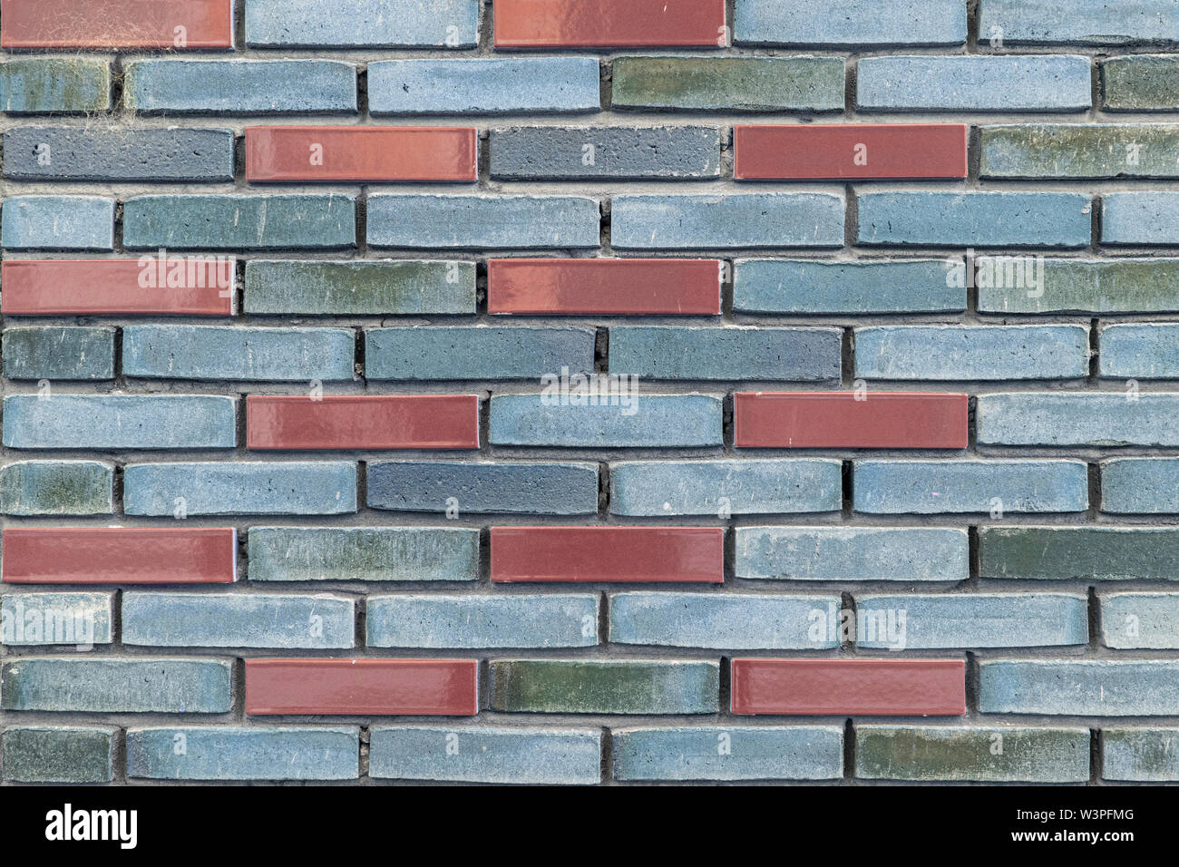 Mur de brique bleu et gris avec quelques briques de couleur brune dans ...