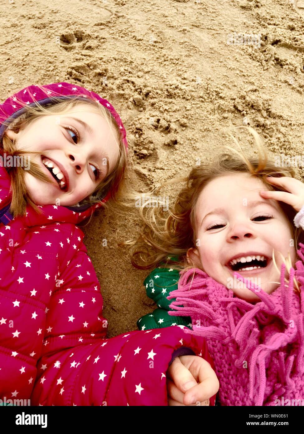 Fillettes Couchées Sur Le Sable Banque De Photographies Et Dimages à