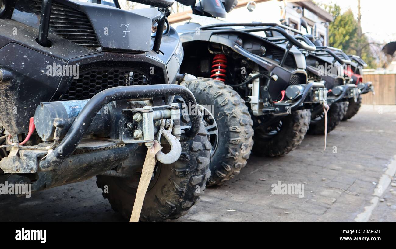 Molti ATV parcheggiati su una strada sterrata, da vicino. Auto a ...