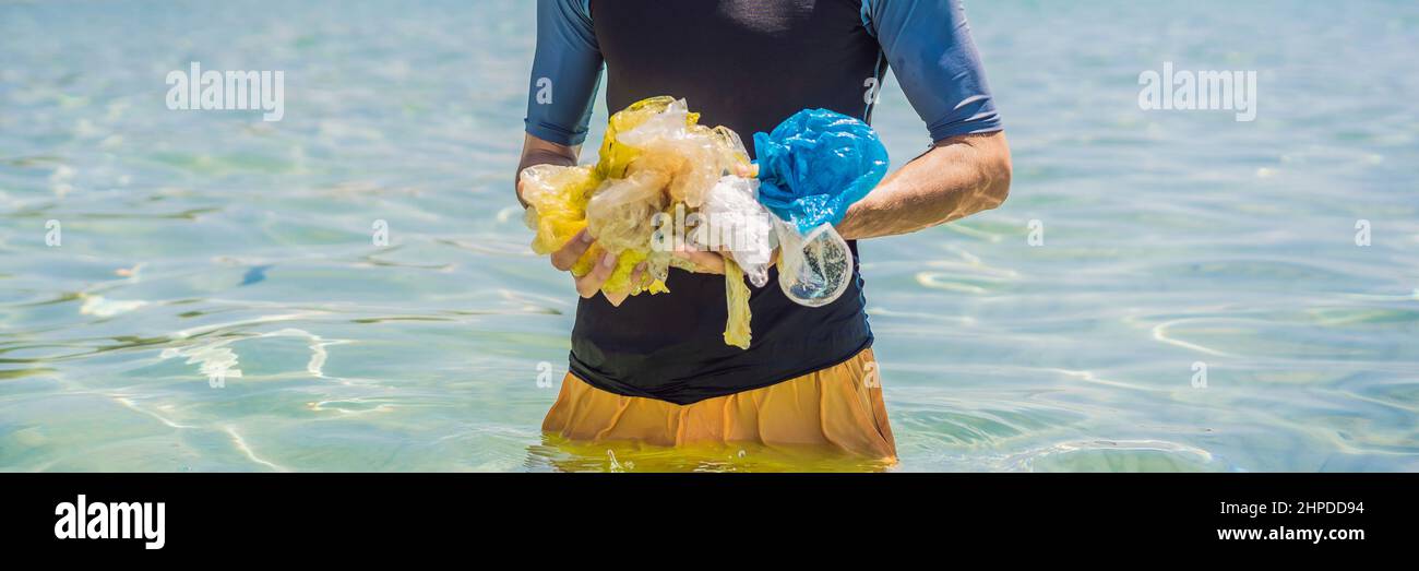 L'uomo raccoglie pacchetti dal mare turchese. Paradise spiaggia ...