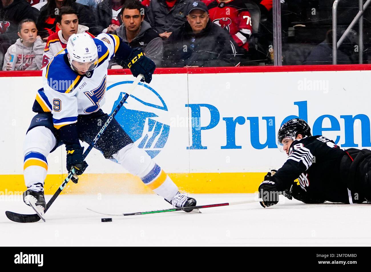 St. Louis Blues' Tyler Pitlick, left, competes for control of the puck ...