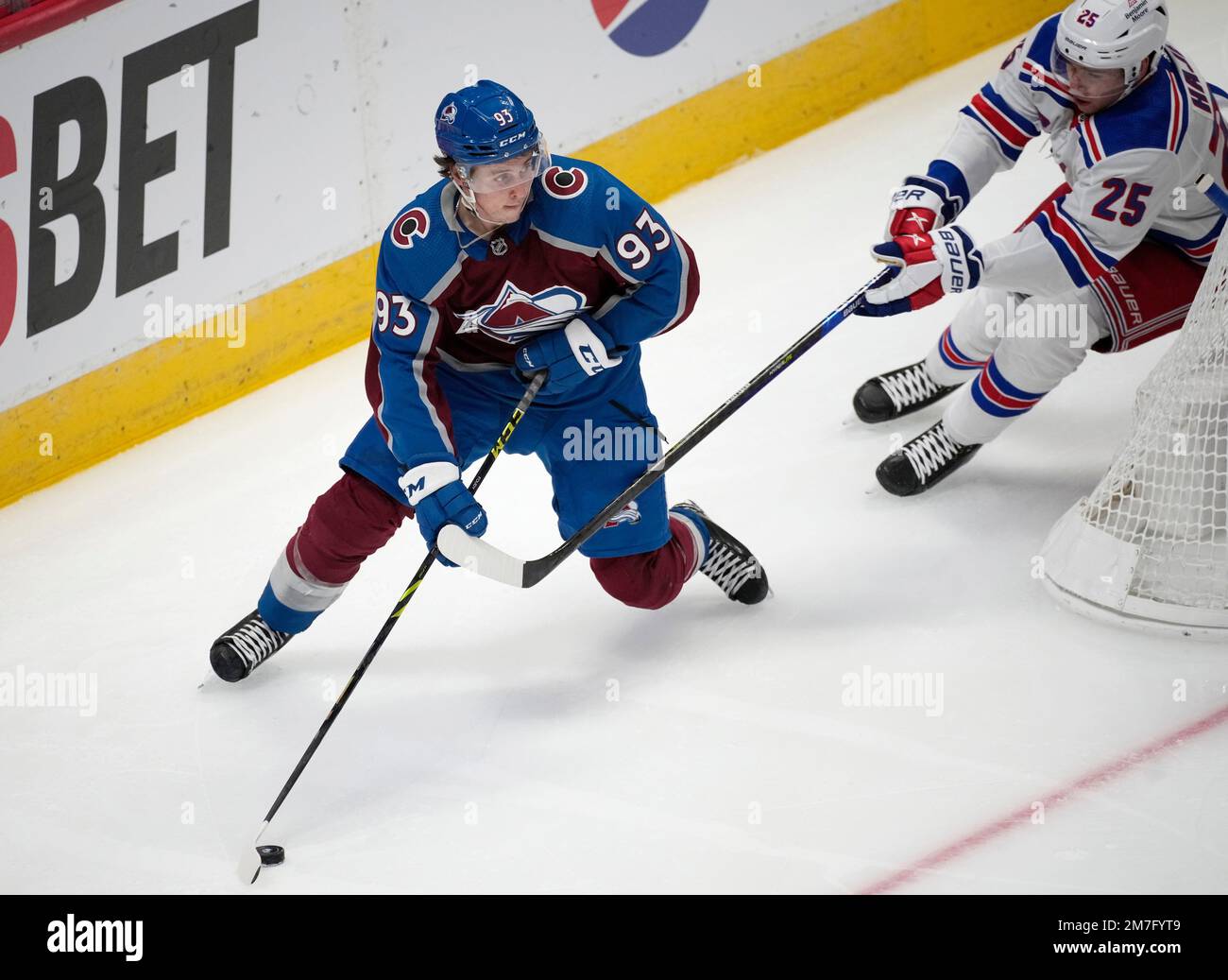 Colorado Avalanche center Jean-Luc Foudy, left, wraps around the net as ...