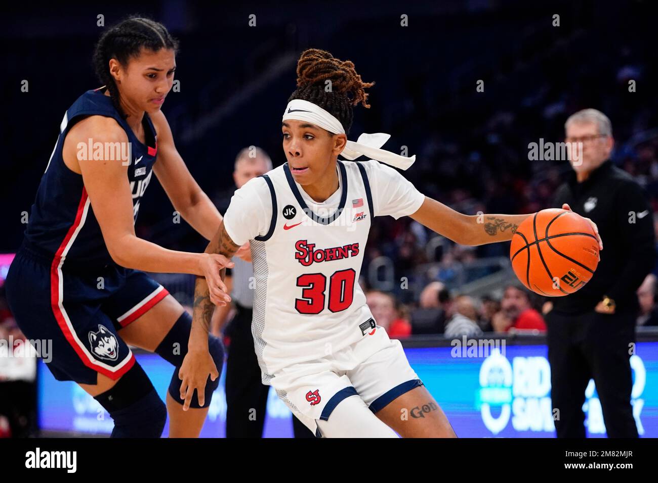St. John's Kadaja Bailey (30) drives past Connecticut's Azzi Fudd (35 ...