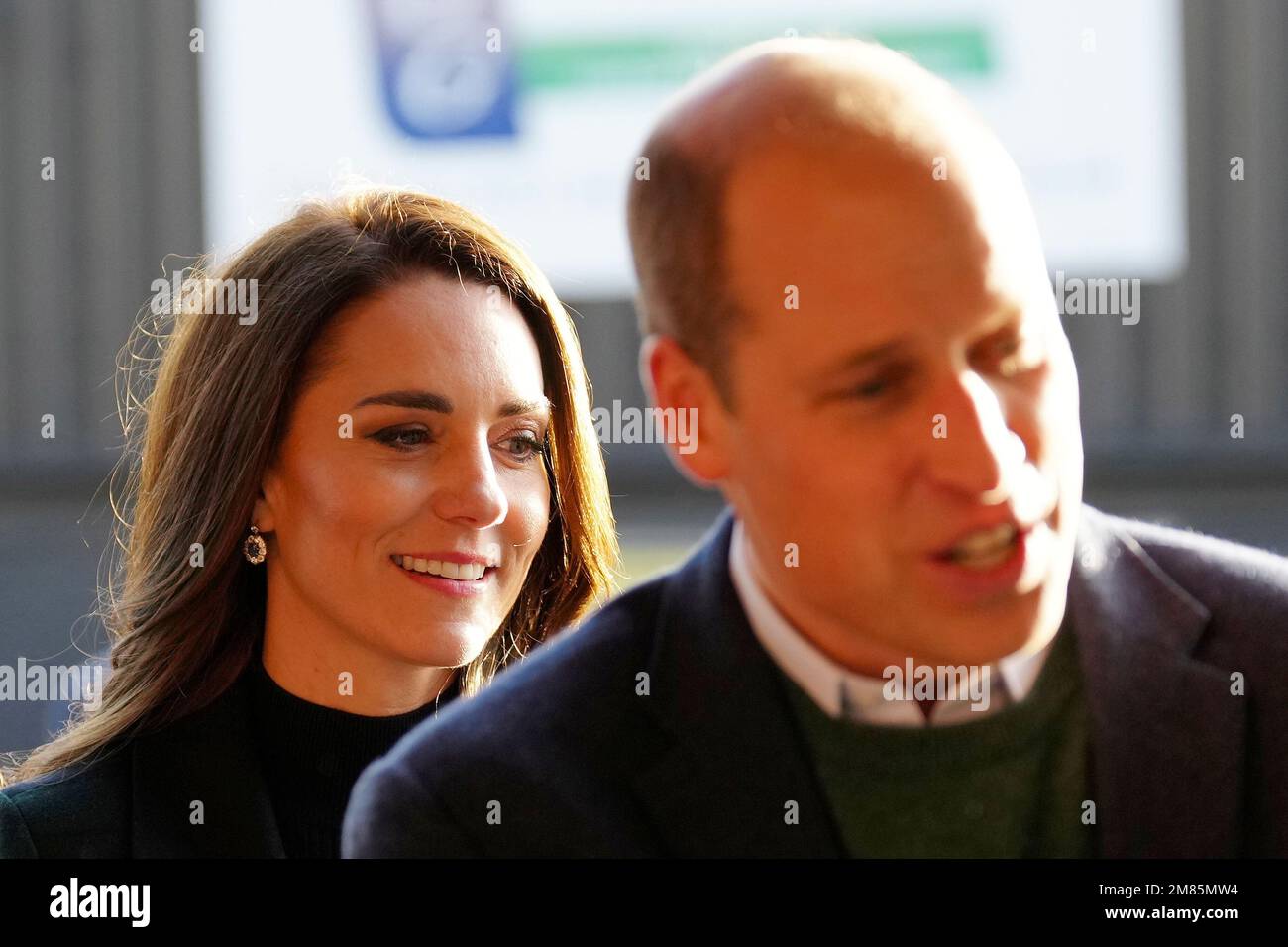 Britain's Kate, Princess of Wales, and Prince William speak to staff ...