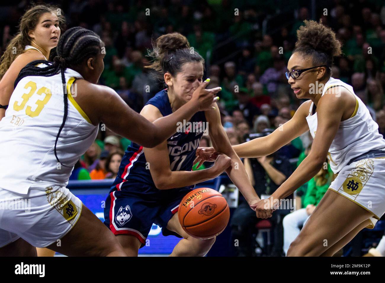 Notre Dame's Lauren Ebo (33) hits Connecticut's Lou Lopez Sénéchal as ...