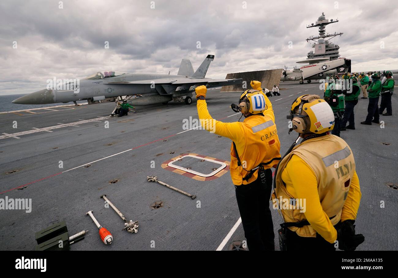 Under the watchful eye of a training officer, right, a catapult officer ...