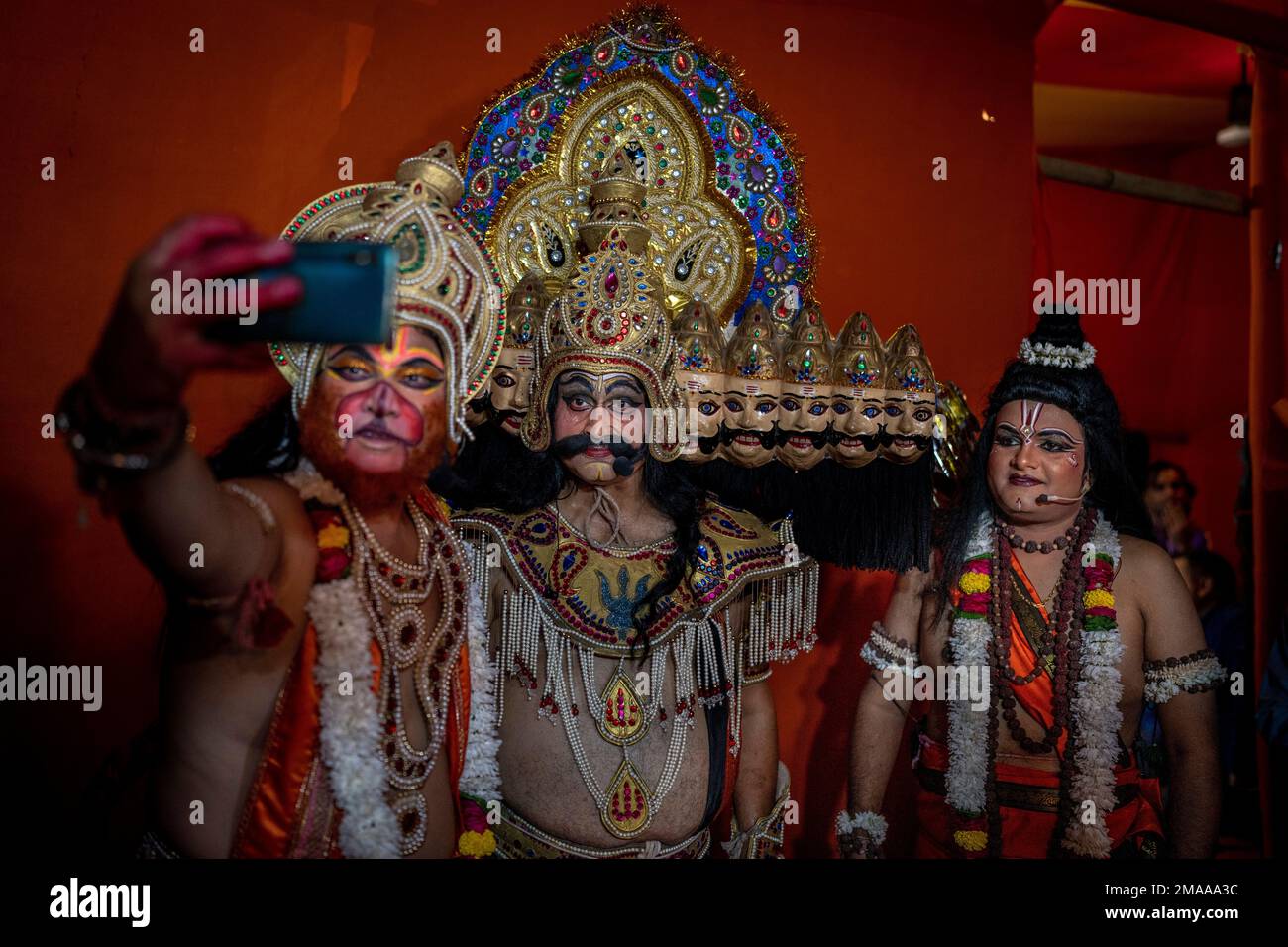An artist dressed as Hindu monkey god Hanuman, left, takes a selfie ...