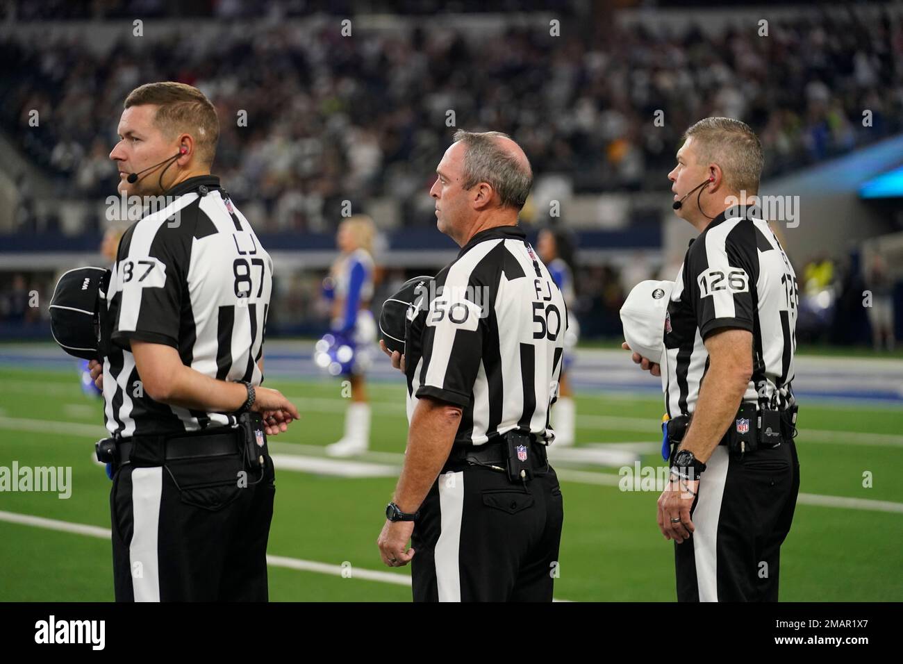 Line judge Tom Eaton (87), field judge Aaron Santi (50) and referee ...