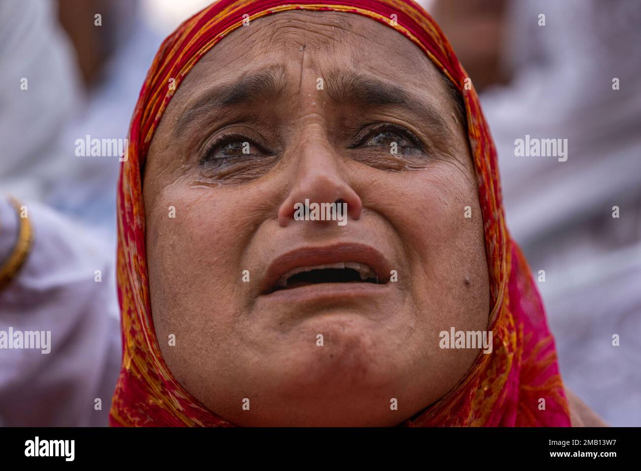 Tears roll down the cheeks of a Kashmiri Muslim woman as the head ...