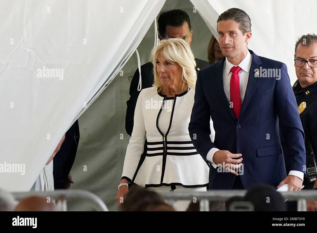 First lady Jill Biden, left, is escorted to the stage by Surfside, Fla ...