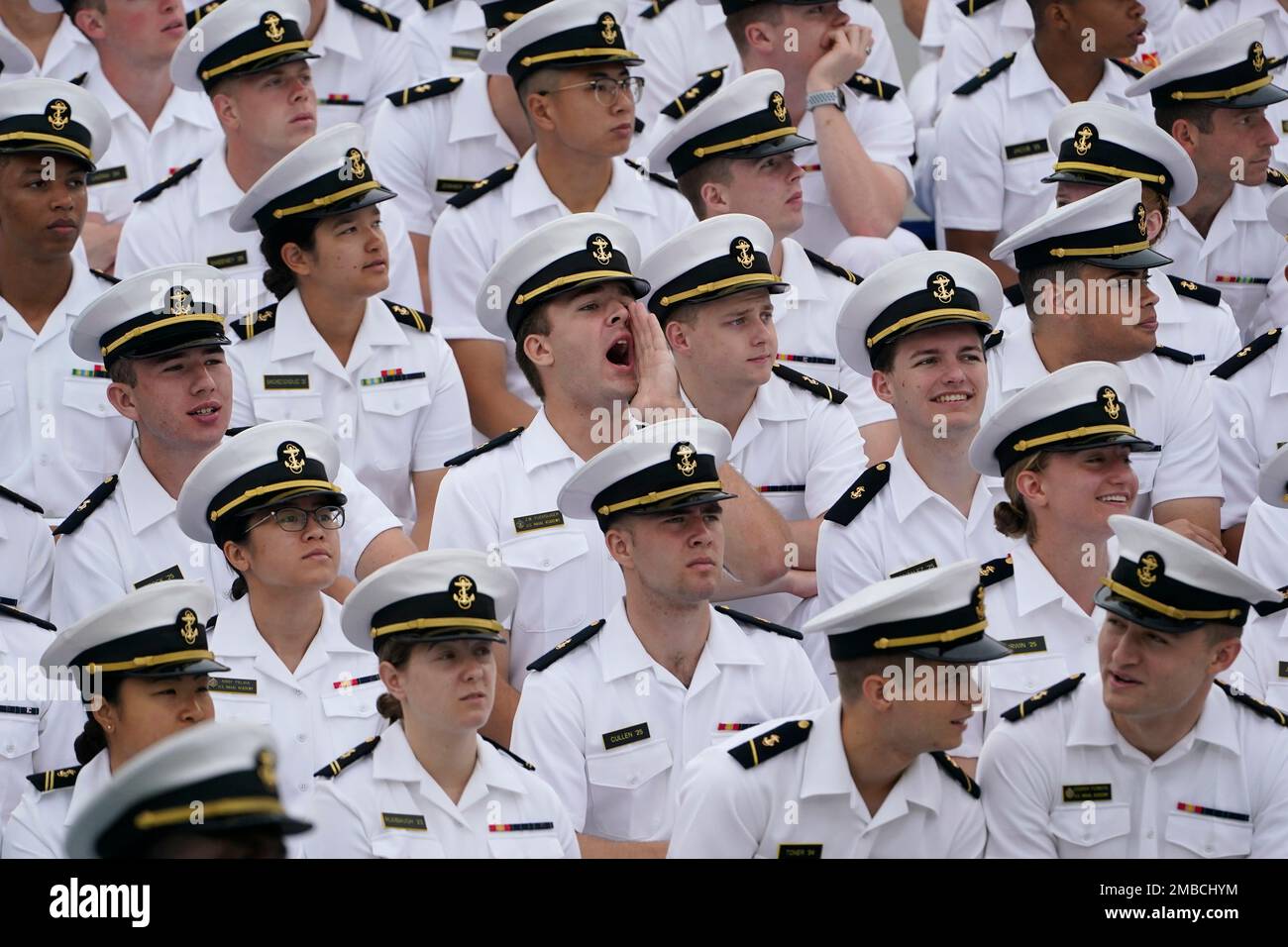 Midshipmen watch as the graduating midshipmen arrive for the U.S. Naval ...