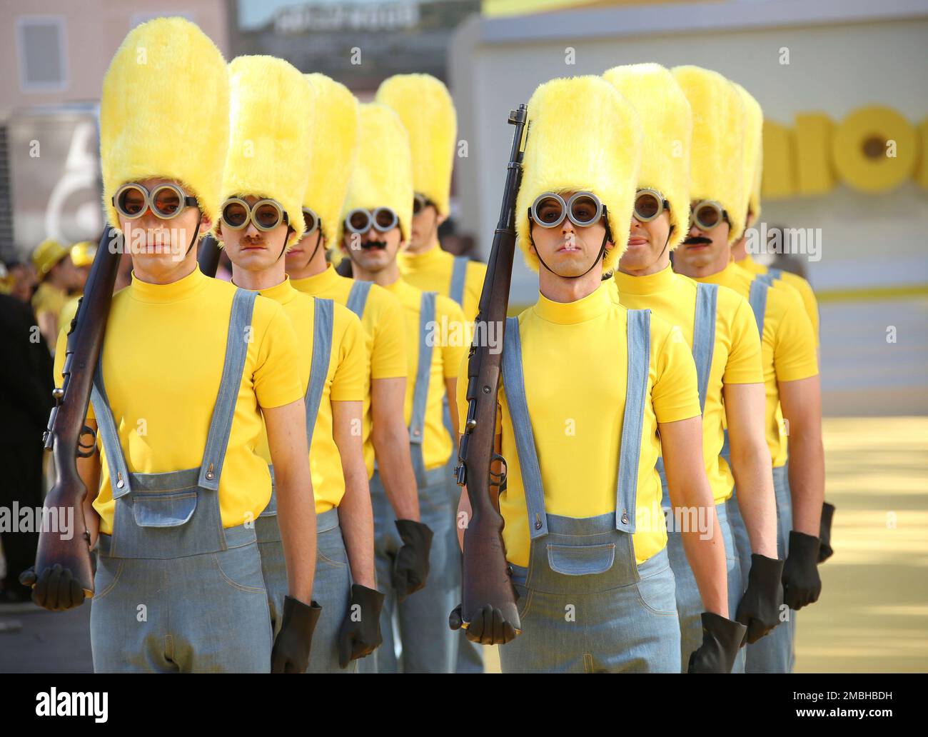 FILE - Actors dressed as Minion guards march down the yellow carpet at ...
