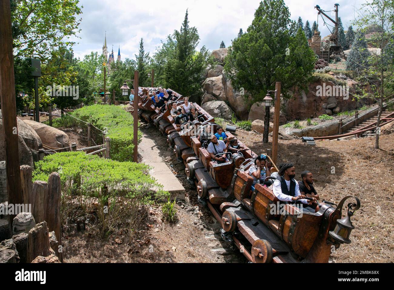 People ride the Seven Dwarfs Mine Train roller coaster at Magic Kingdom ...