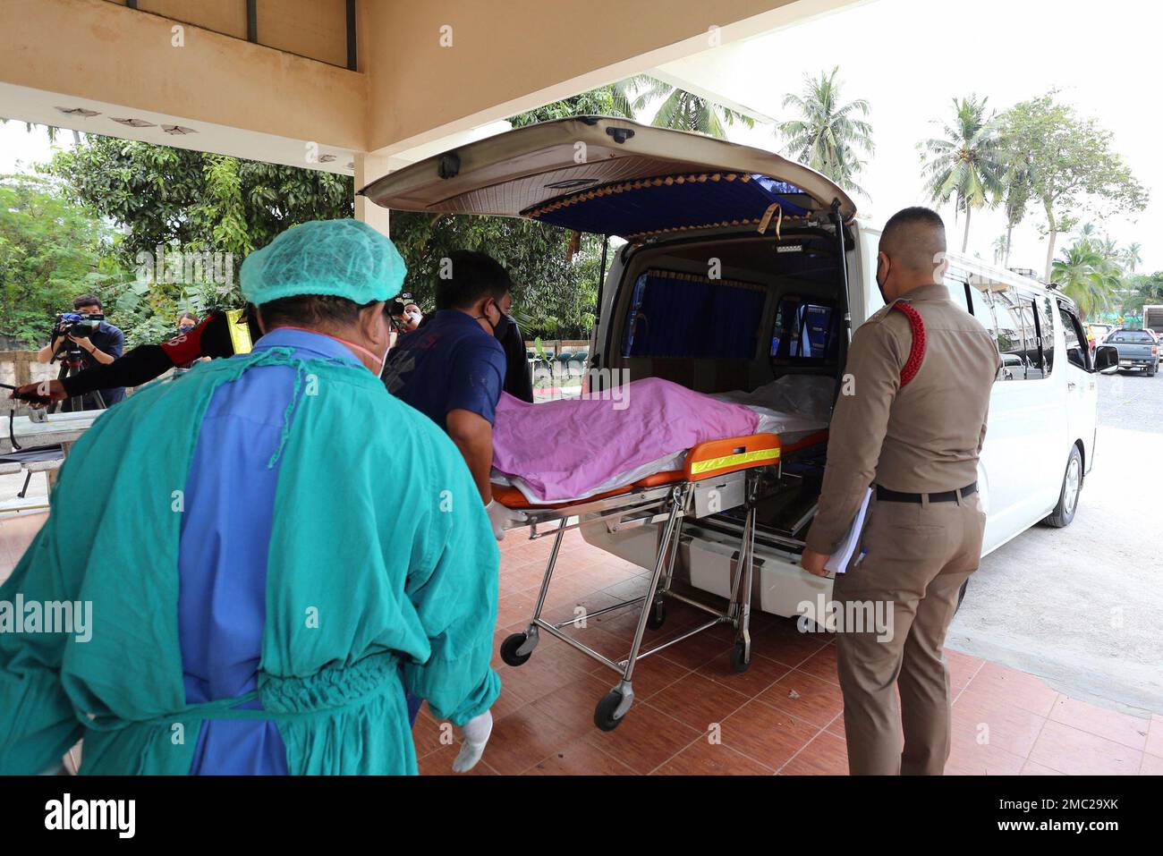 Staff members help move the body of Shane Warne from Ko Samui Hospital ...