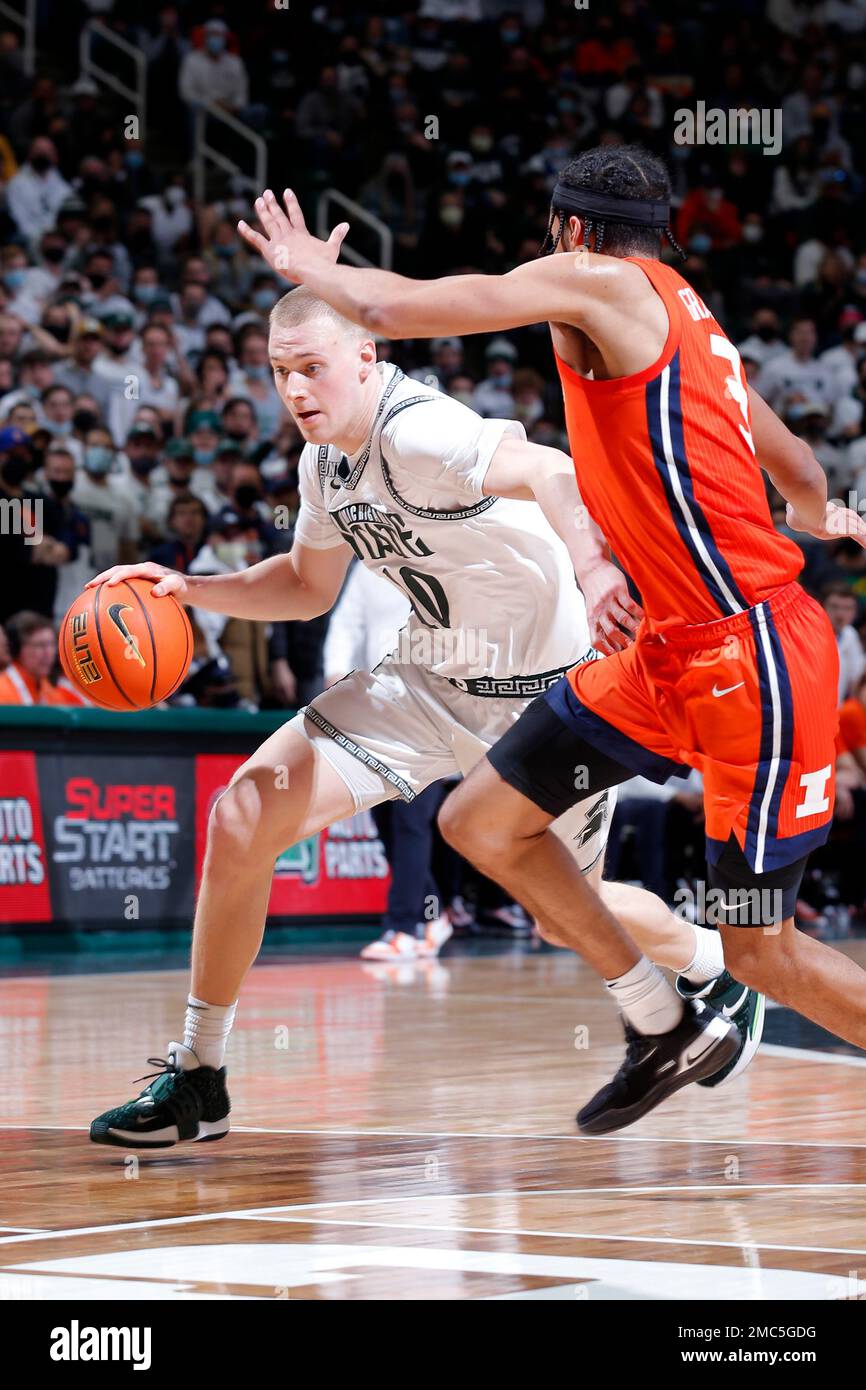 Michigan State's Joey Hauser, left, drives against Illinois' Jacob ...
