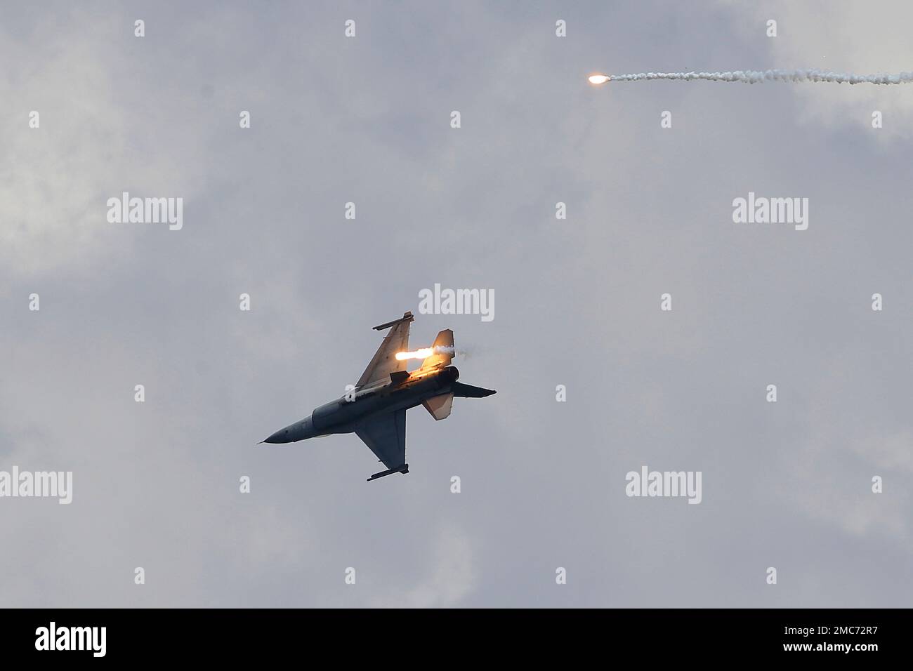 A Republic of Singapore Air Force (RSAF) F-16C fighter jetreleases chaffs while performing an ...