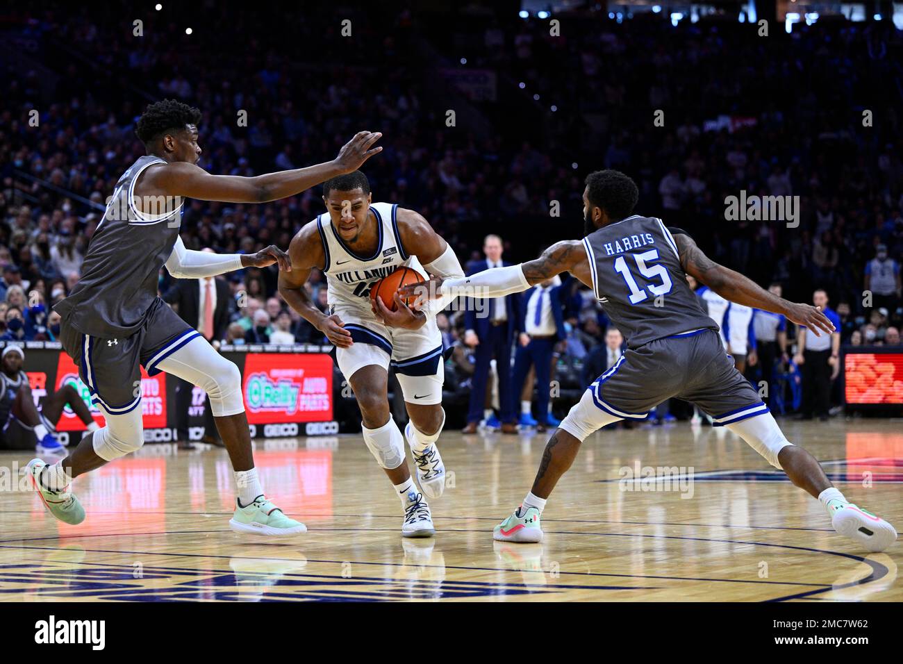 Villanova's Eric Dixon, center, drives past Seton Hall's Alexis Yetna ...