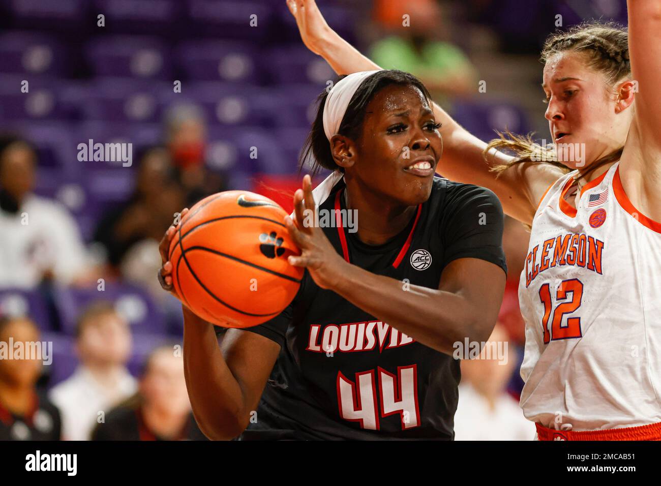 Louisville forward Olivia Cochran, left, looks to pass the ball against ...