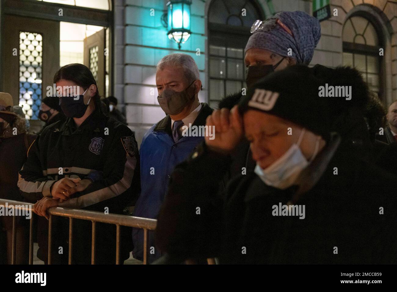 NYPD officers attend a candlelight vigil outside the New York City ...