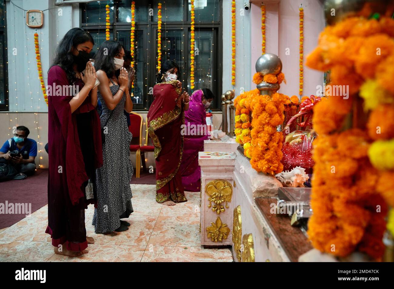 Hindu devotees pray at a temple during Diwali, the festival of lights ...