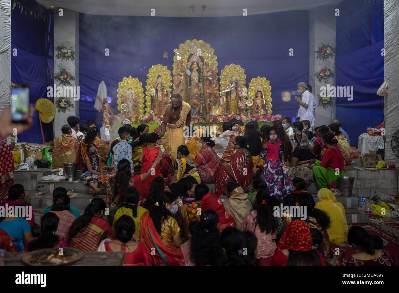 Devotees worship front of an idol of Hindu goddess Durga inside a ...