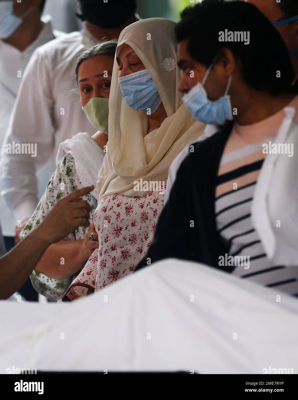 Saira Banu, wife of Indian actor Dilip Kumar, wearing blue mask, center ...