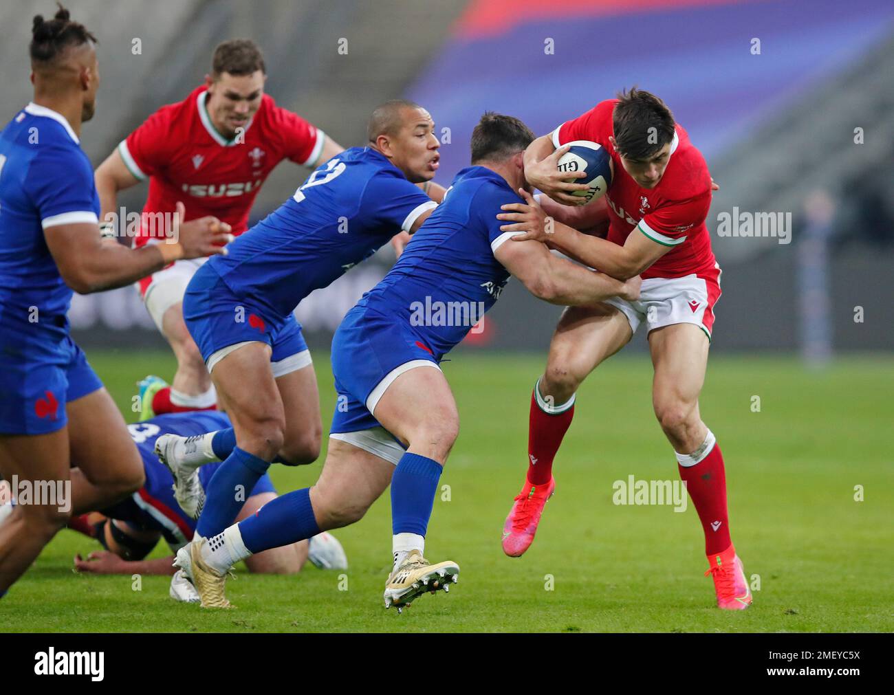 Wales' Louis Rees Zammit, right, is tackled by France's Julien Marchand ...