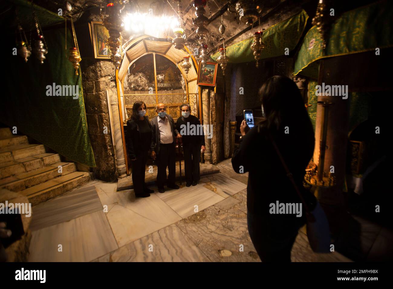 Christians take photos inside the Grotto of the Church of the Nativity ...