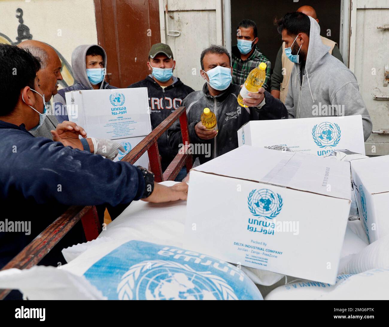 Palestinian workers load food supplies distributed by the United ...
