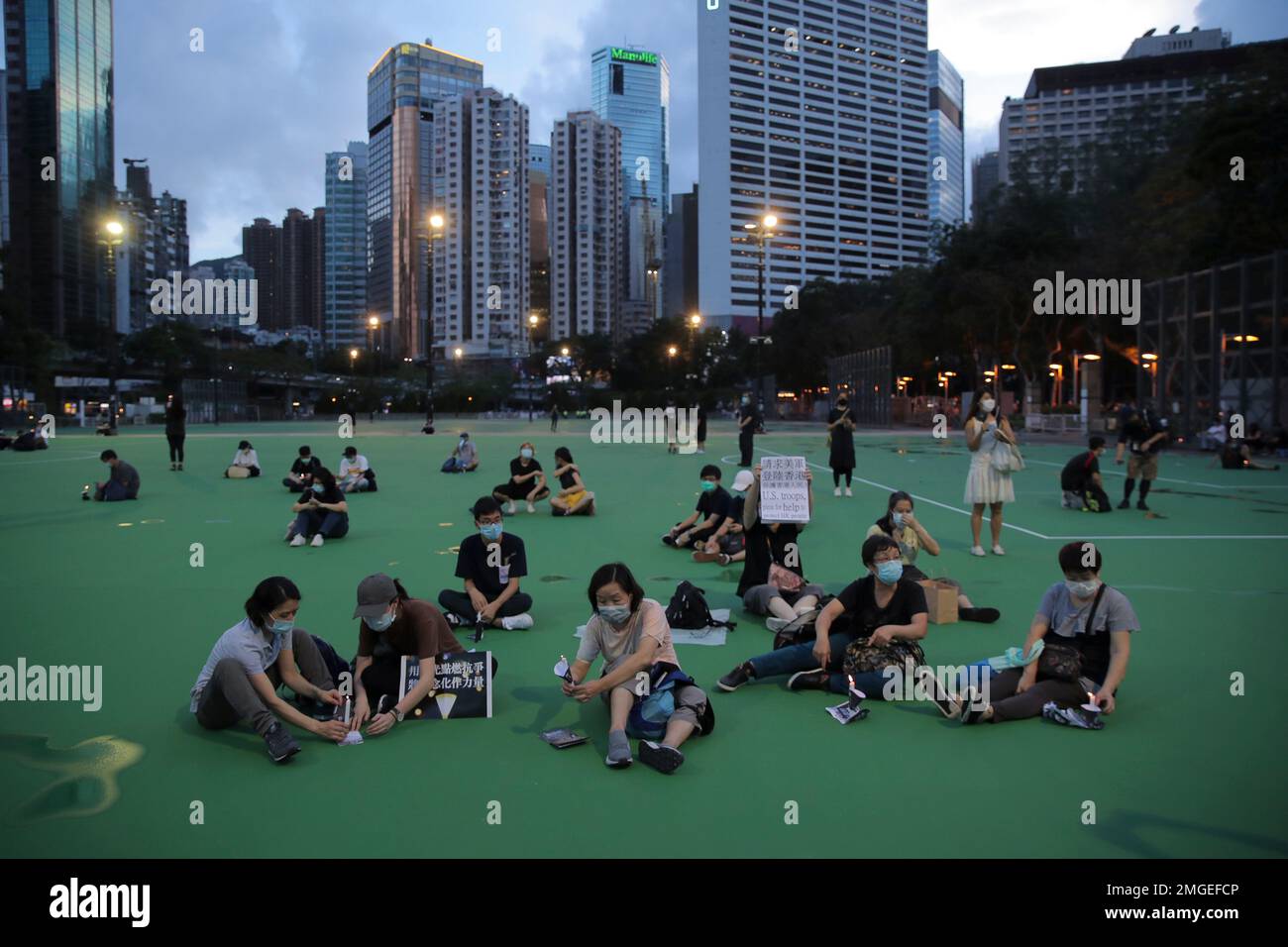 Participants hold candles as they gather for a vigil to remember the ...