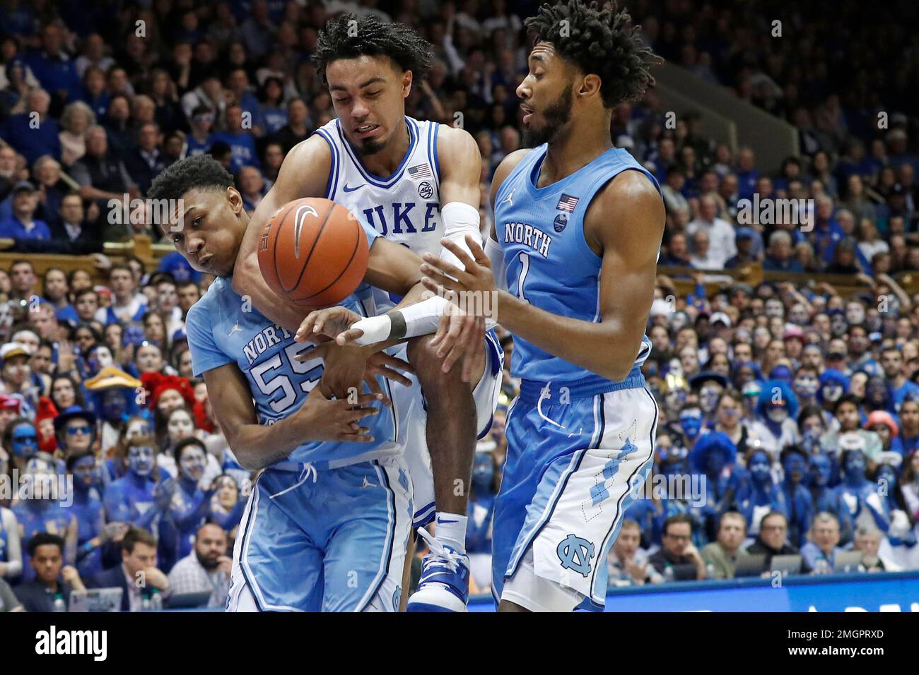 Duke guard Tre Jones drives between North Carolina guard Christian ...