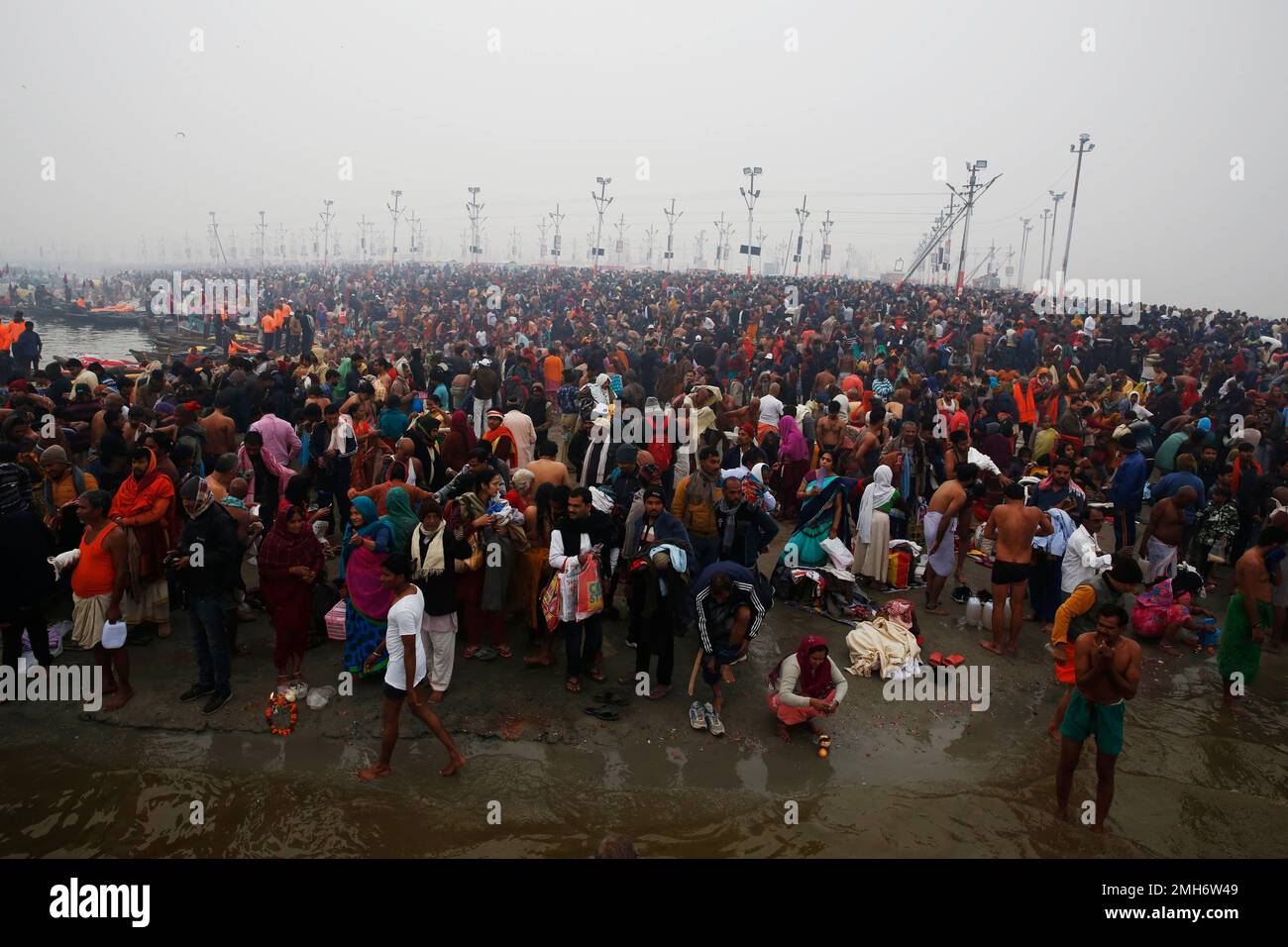 Hindu devotees crowd the confluence of the Ganges and Yamuna rivers to take a ritualistic bath ...