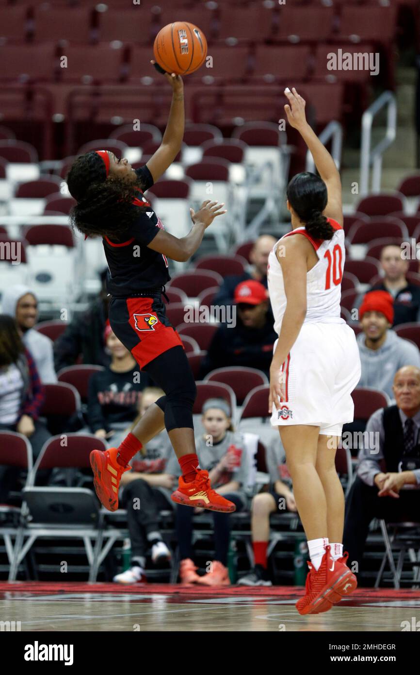 Louisville guard Dana Evans, left, goes up for a shot in front of Ohio ...