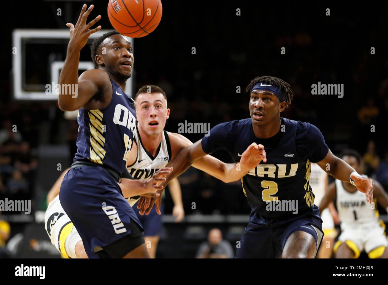 Oral Roberts' R.J. Fuqua, left, and Deondre Burns, right, fight for the ...