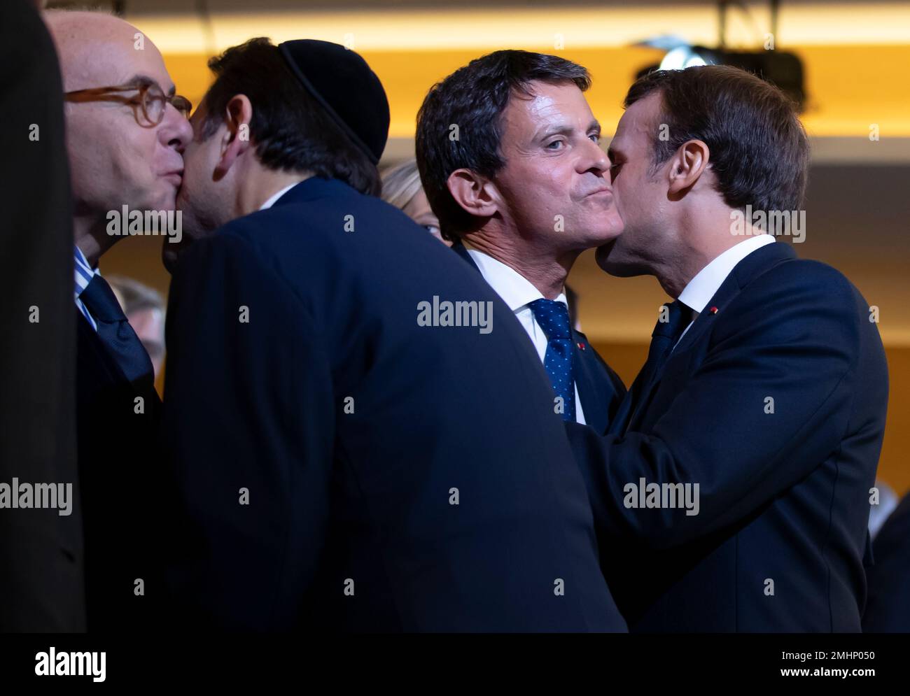 French President Emmanuel Macron, right, embraces Former French Prime ...