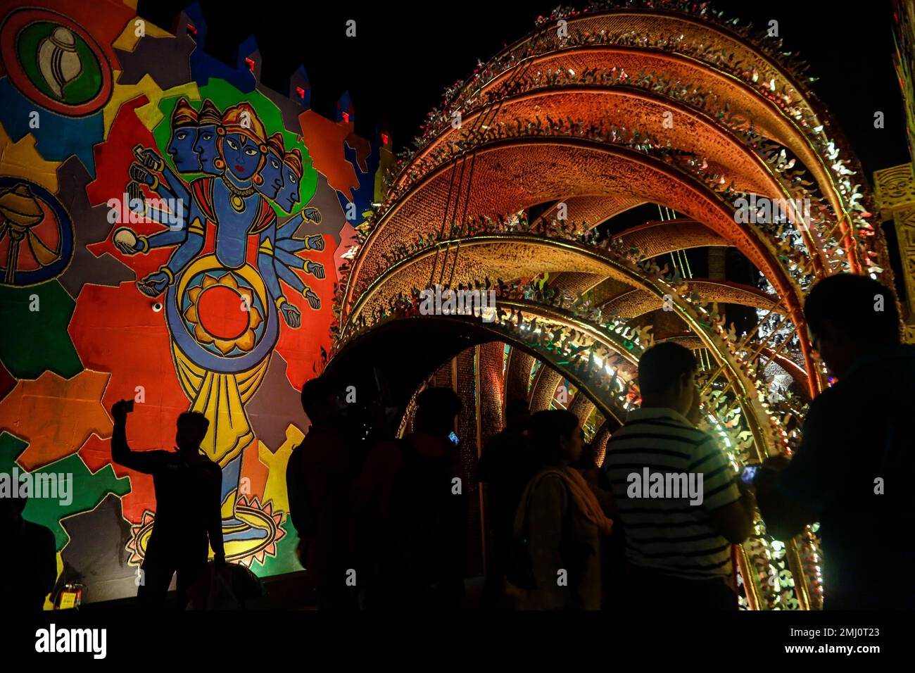 Devotees throng inside a "pandal," or a temporary structure set up to ...