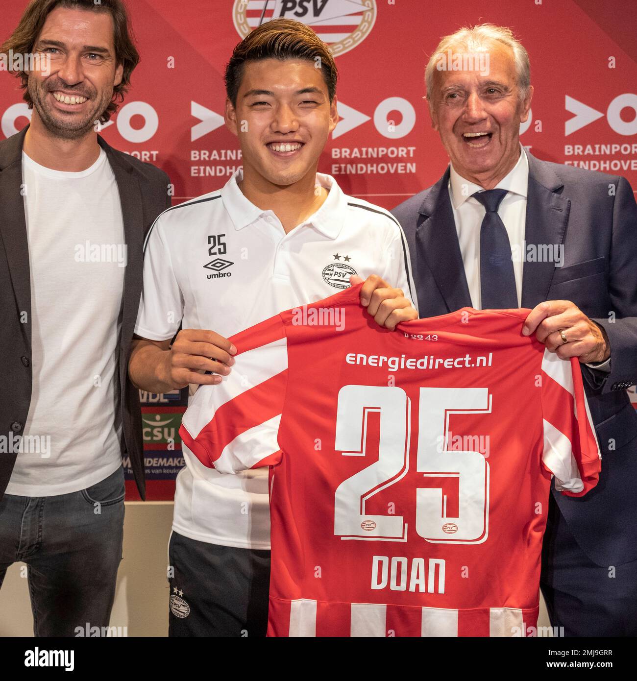 Japanese soccer player Ritsu Doan, center, holds the team shirt after ...