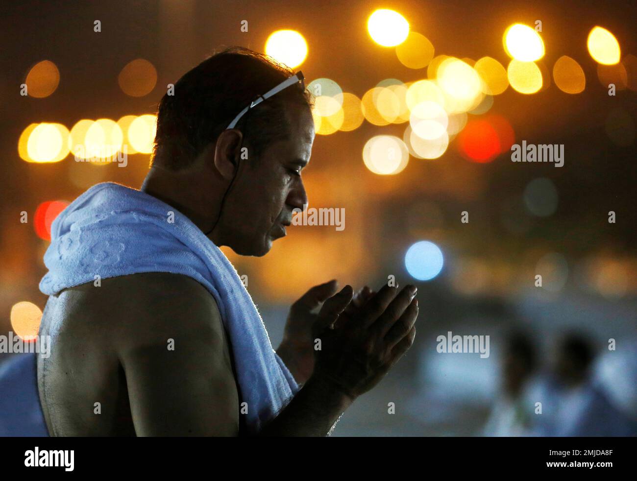 A Muslim pilgrim prays on a rocky hill known as Mountain of Mercy, on ...