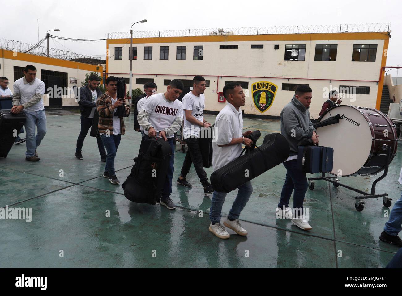 In this July 19, 2019 photo, handcuffed inmates, instruments in tow ...
